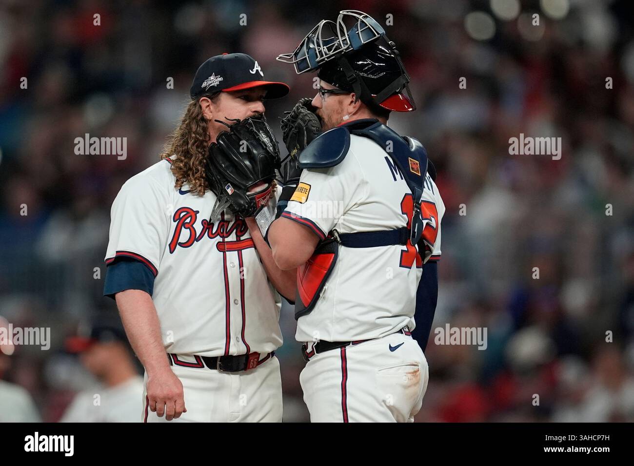 Atlanta Braves' Grant Holmes. left, and Sean Murphy (12) speak on the ...