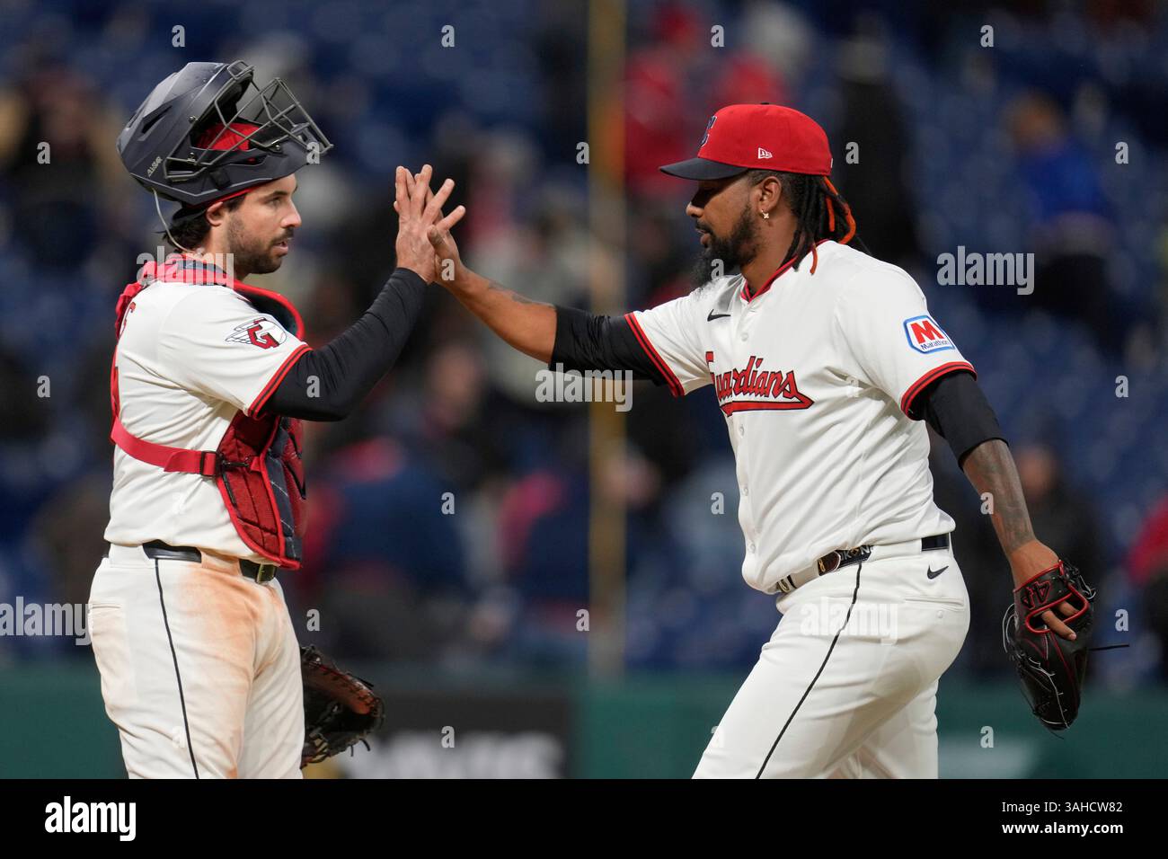 Cleveland Guardians catcher Austin Hedges, left, and relief pitcher ...