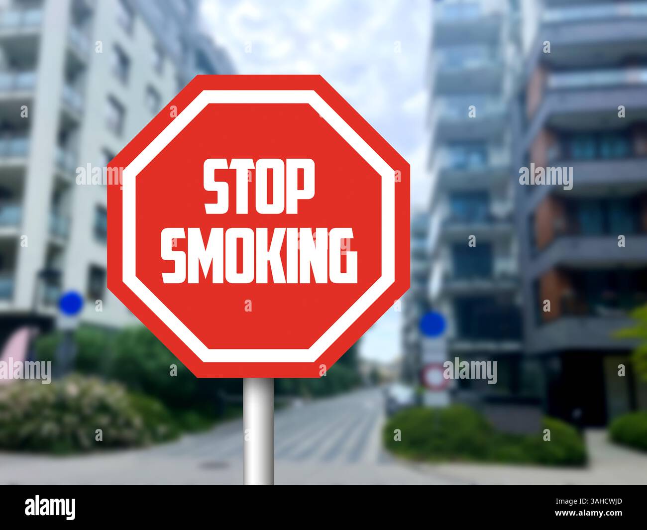 Stop Smoking sign on city street with buildings Stock Photo - Alamy