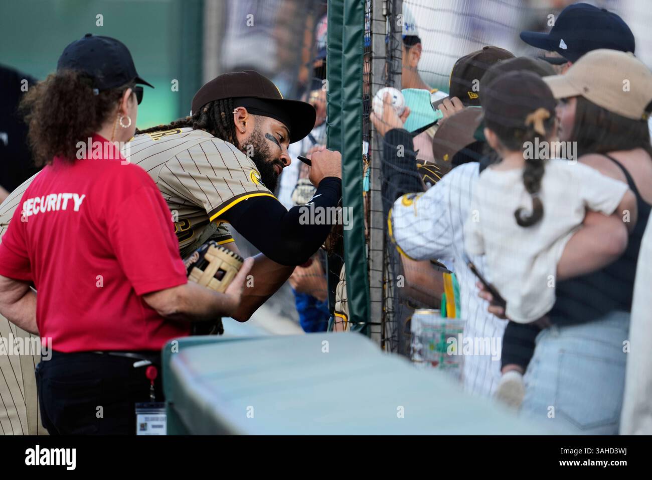 San Diego Padres' Fernando Tatis Jr. signs an autograph for a fan ...