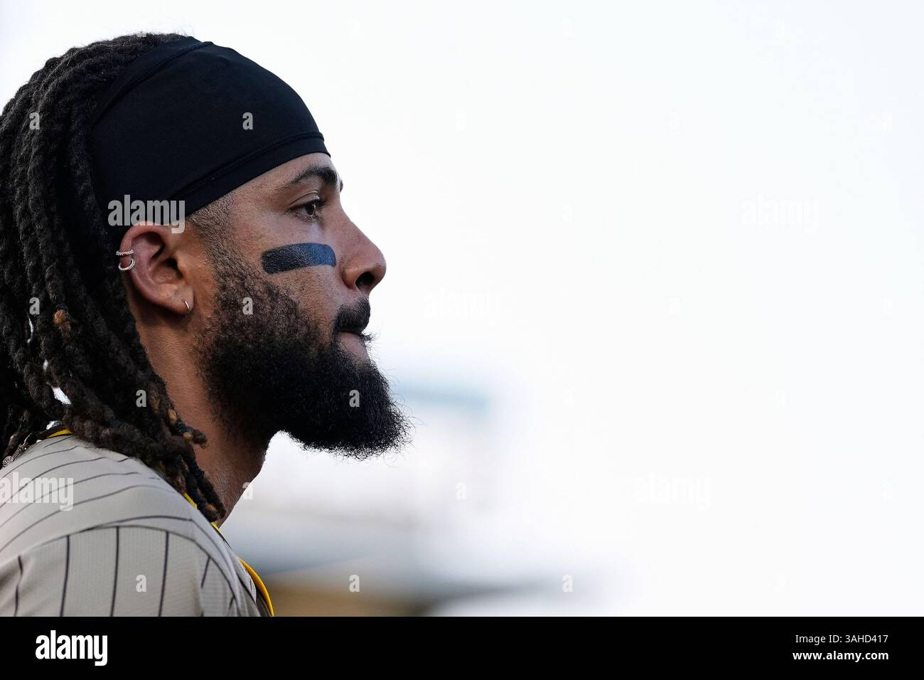 San Diego Padres' Fernando Tatis Jr. listens to the national anthem before a baseball game ...