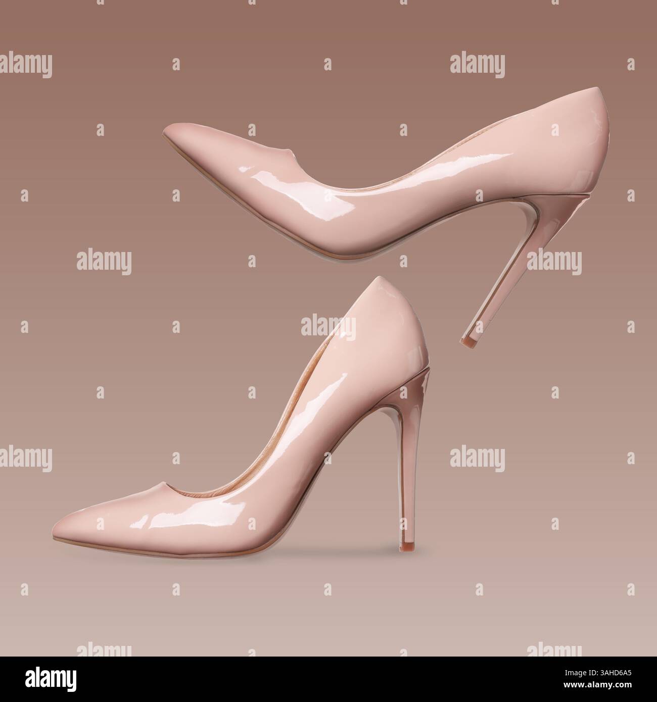 Stylish beige high heel shoes in air on pale brown gradient background ...