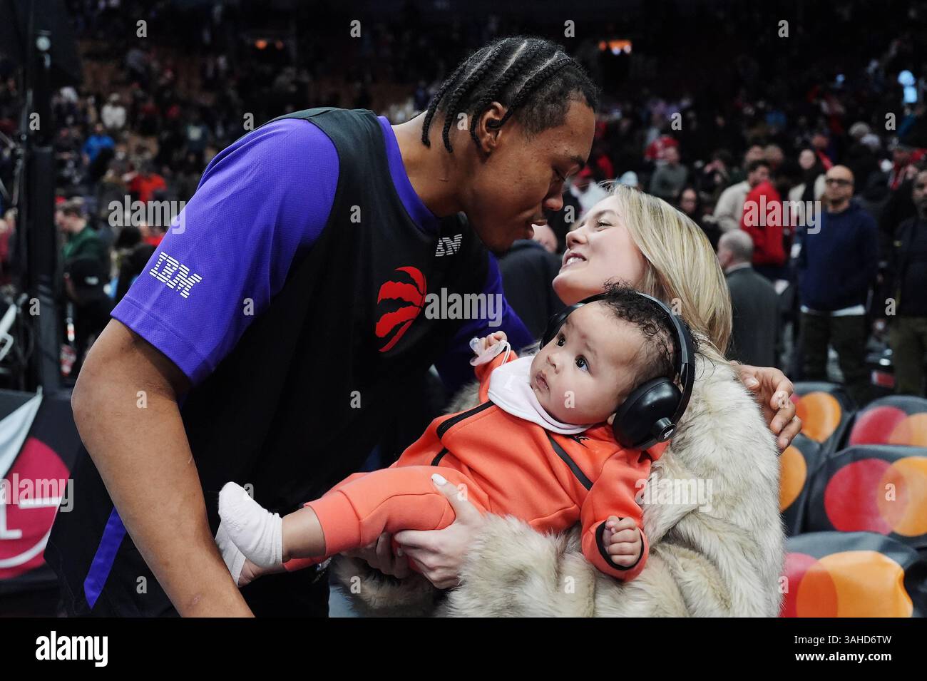 Toronto Raptors' Scottie Barnes embraces his girlfriend Alyssa Rae Holmes and their child after ...