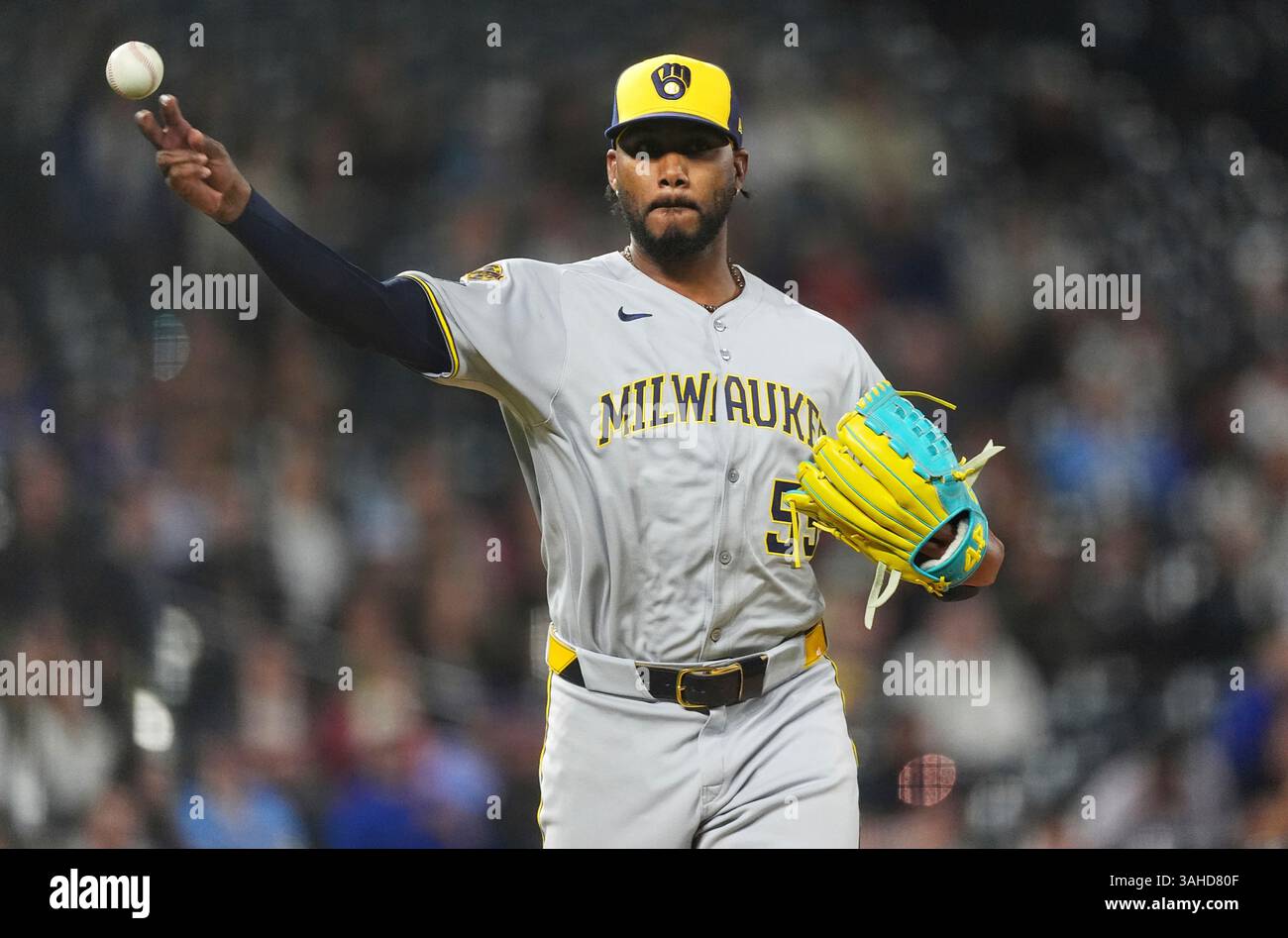 Milwaukee Brewers relief pitcher Elvis Peguero throws to first base to ...
