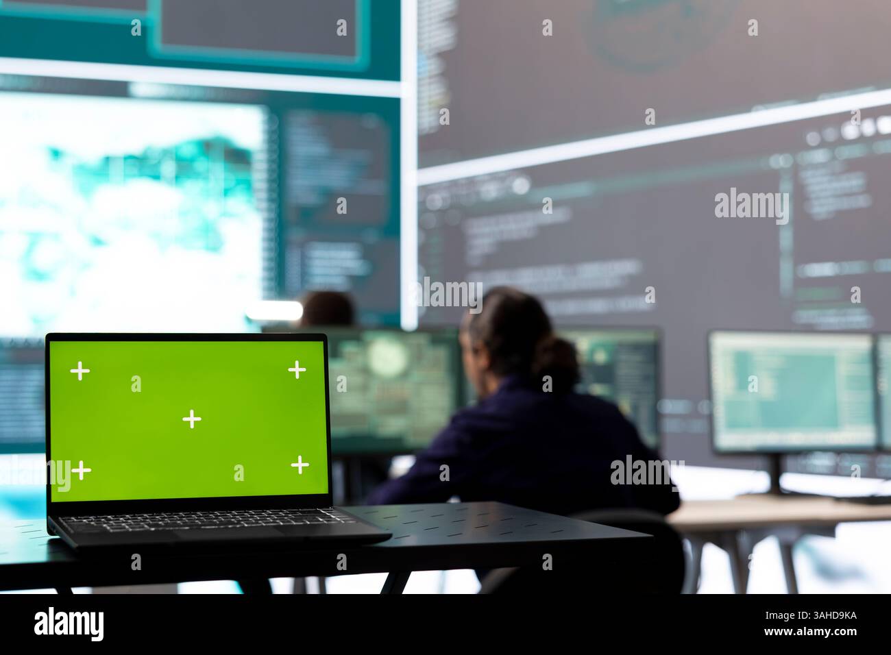 Laptop showing green screen in a governmental high tech office, cyber ...