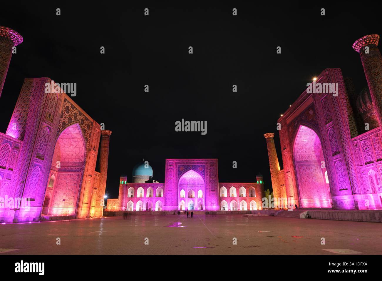 View of the colorful purple light show at night on the buildings. At ...