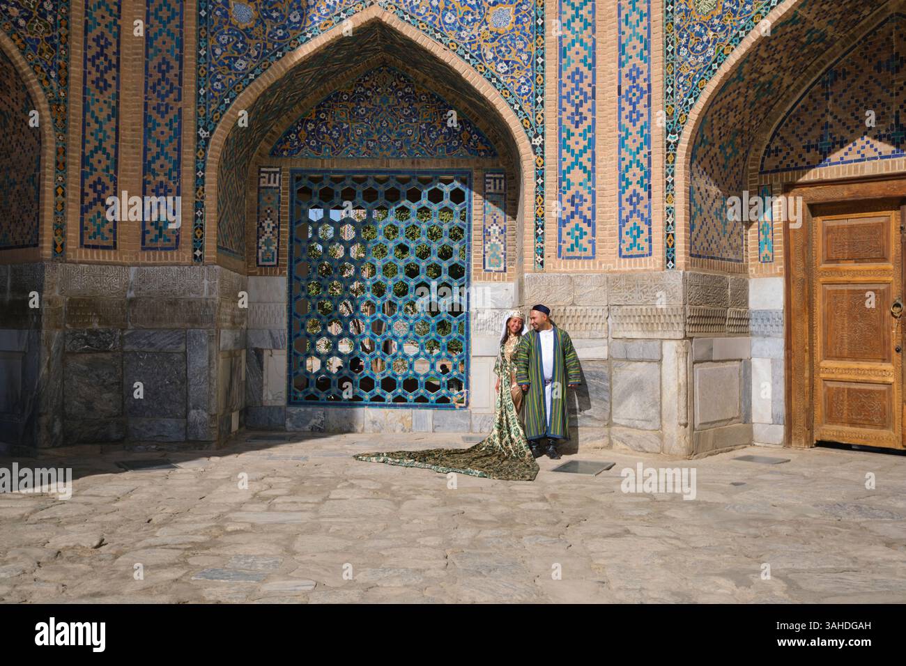 A young couple dresses up in traditional ethnic costume, chapan and ...
