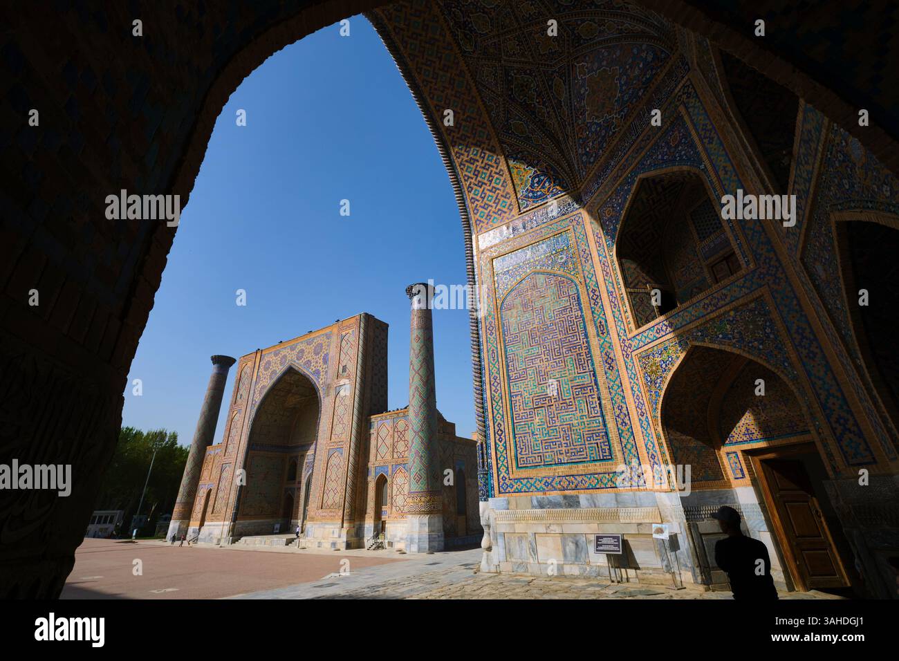 Doorway, shadow arch view of Ulugh Bek Madrassah. At the Silk Road site, The Registan. In ...
