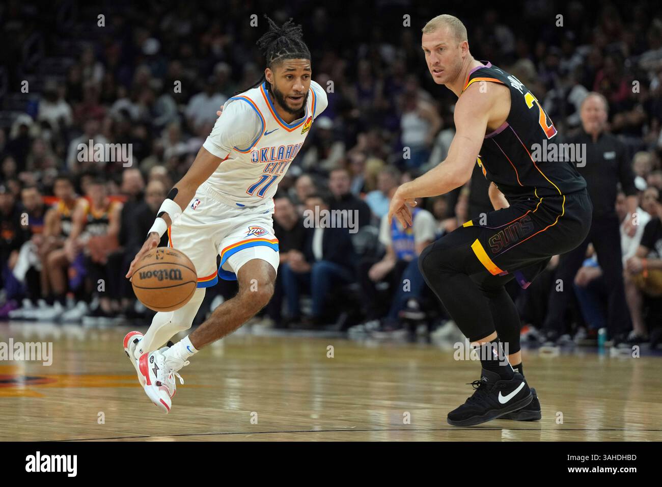Oklahoma City Thunder guard Isaiah Joe (11) drives around Phoenix Suns center Mason Plumlee ...
