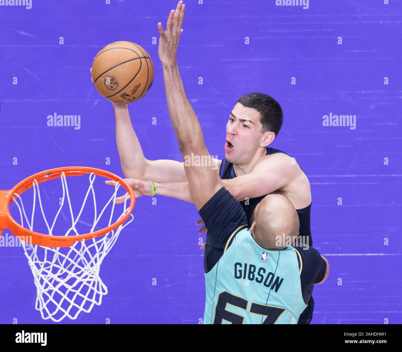 Toronto, Canada. 9th Apr, 2025. Cole Swider (back) of Toronto Raptors ...