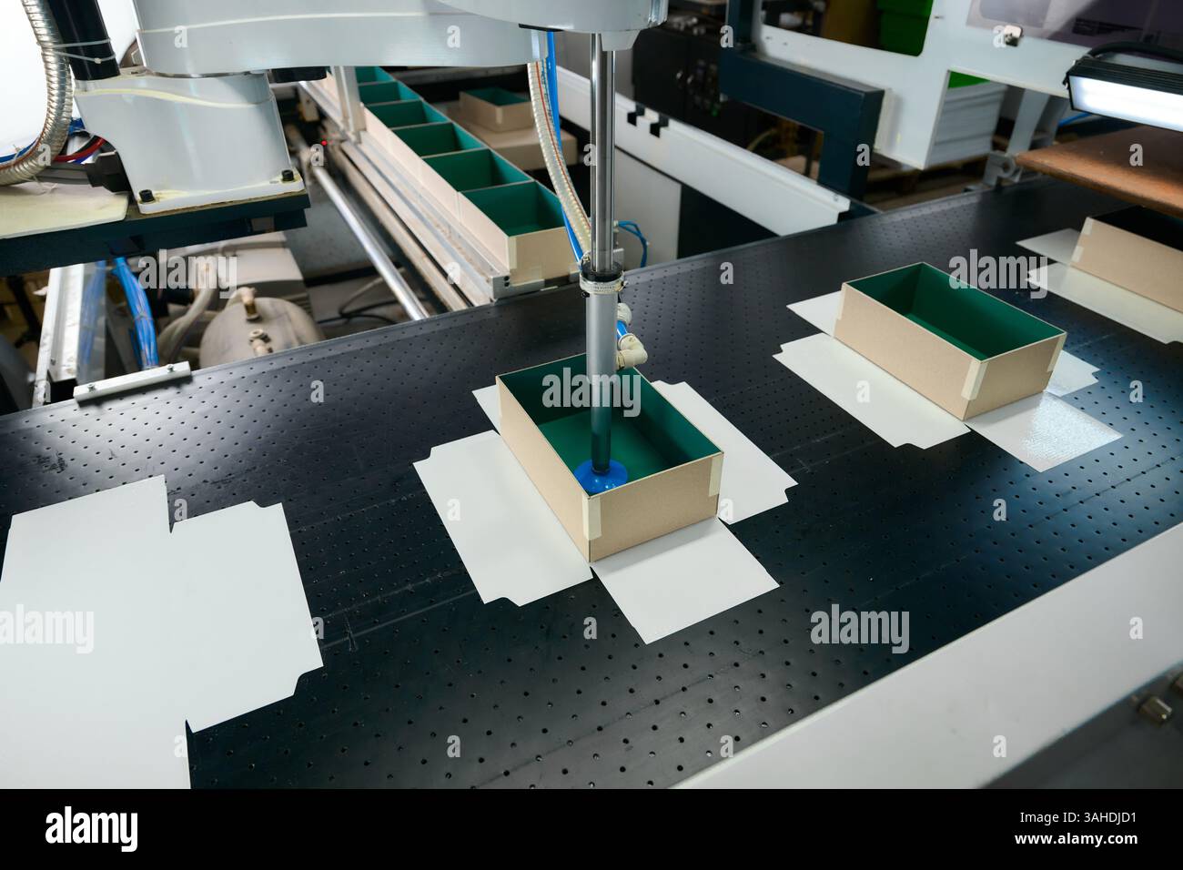 Efficient robot gluing process at a modern box manufacturing plant for precision cardboard ...