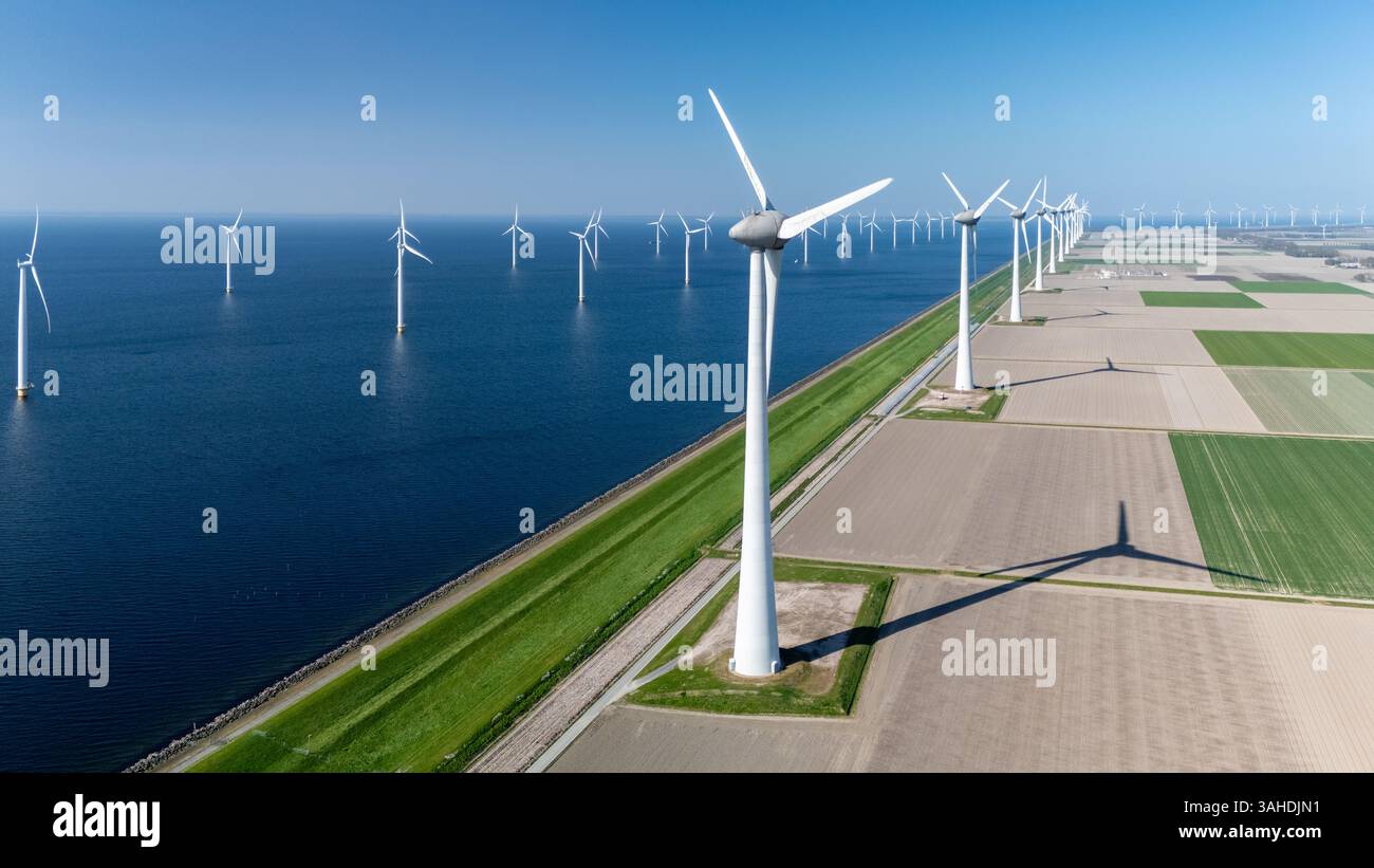 Expansive offshore wind farm featuring numerous wind turbines set ...