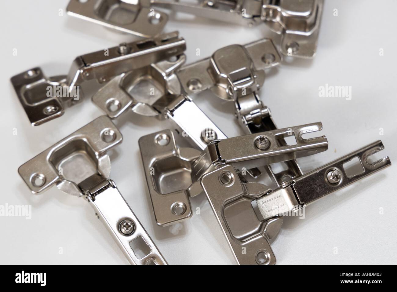 Metal hinges for a wardrobe cabinet shown in close-up. Suitable for ...