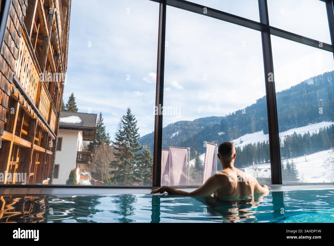 Indoor Pool Overlooking Snow Covered Italian Alps and Chalet Stock ...
