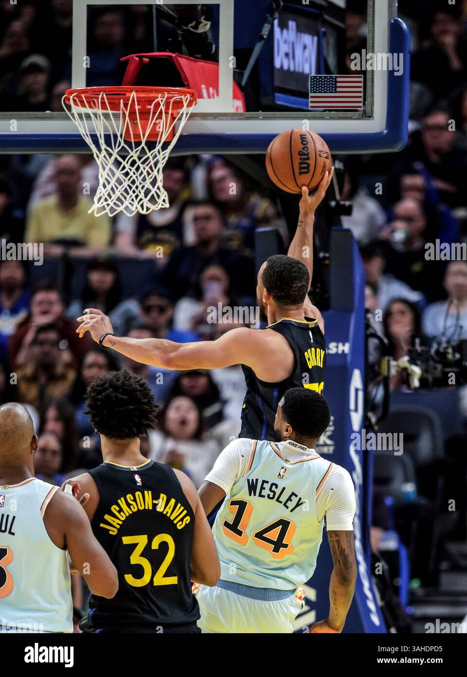 Stephen Curry (30) puts up a shot while falling backward, making it and ...