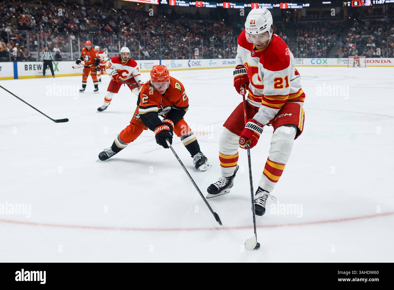 Calgary Flames center Kevin Rooney, right, controls the puck away from ...