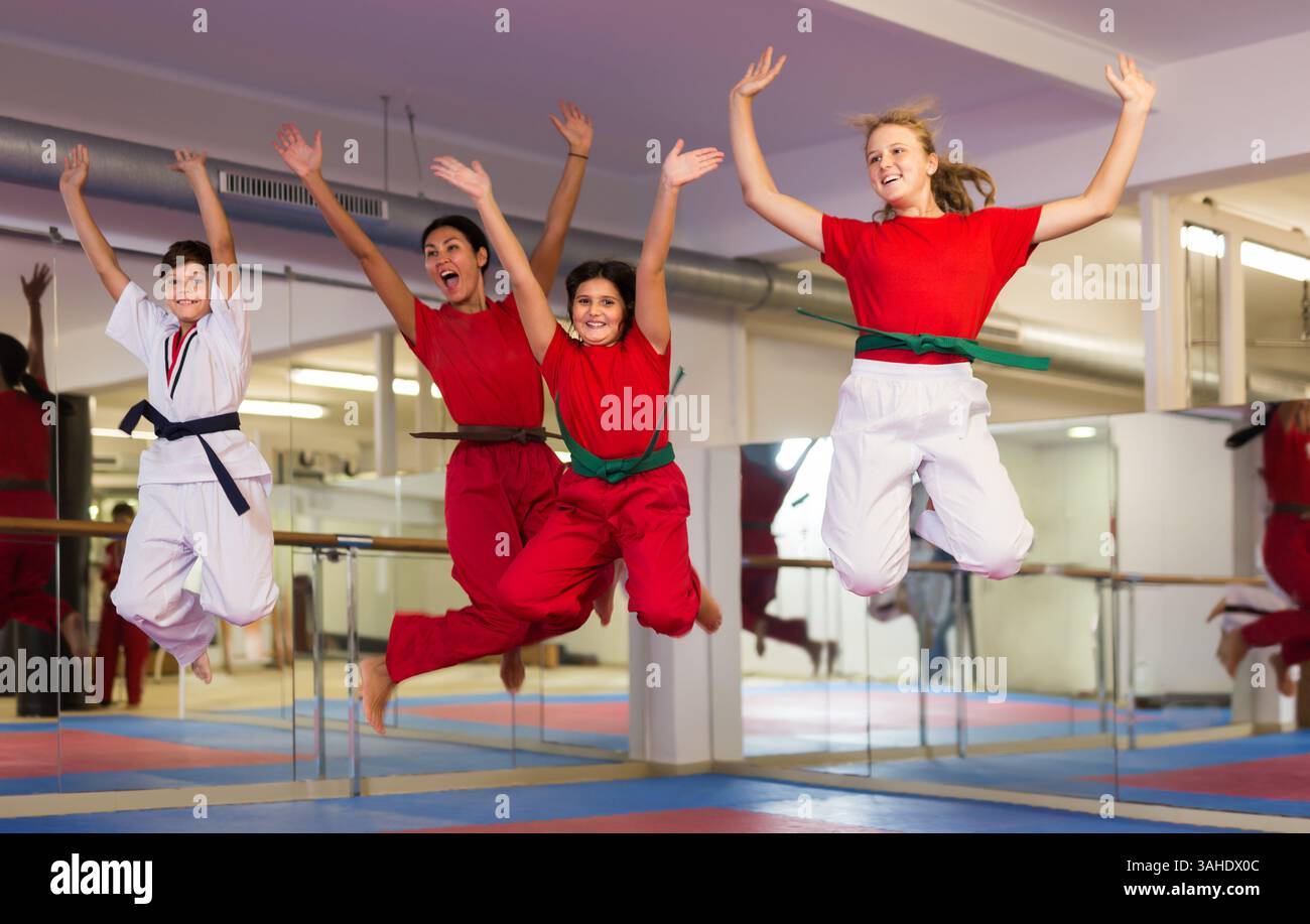 Kids and karate trainer jumping in gym Stock Photo - Alamy