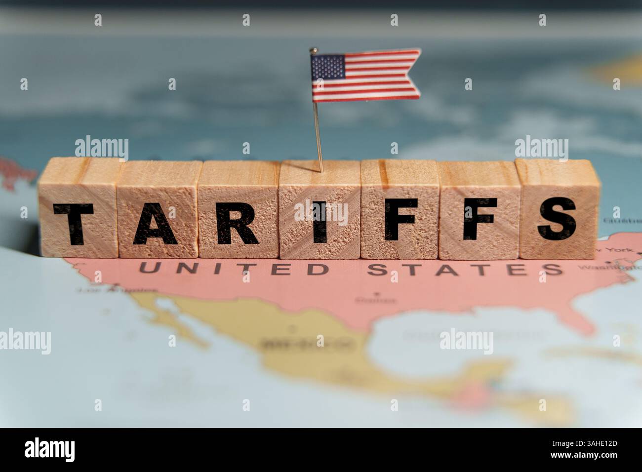 Wooden blocks spelling the word TARIFFS with a small US flag placed on ...