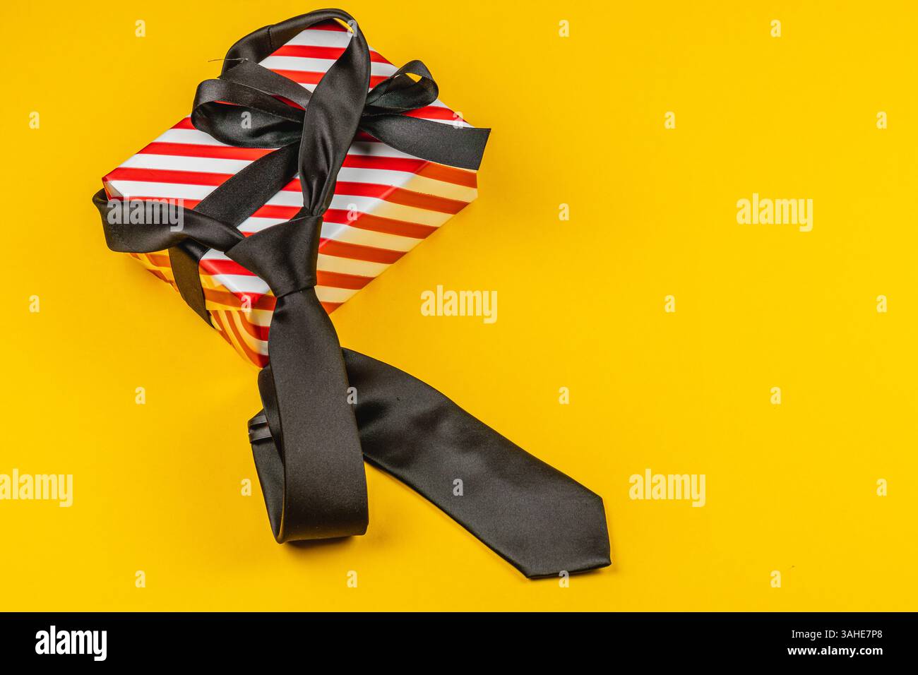 This vibrant display features a neatly wrapped gift with striped ...