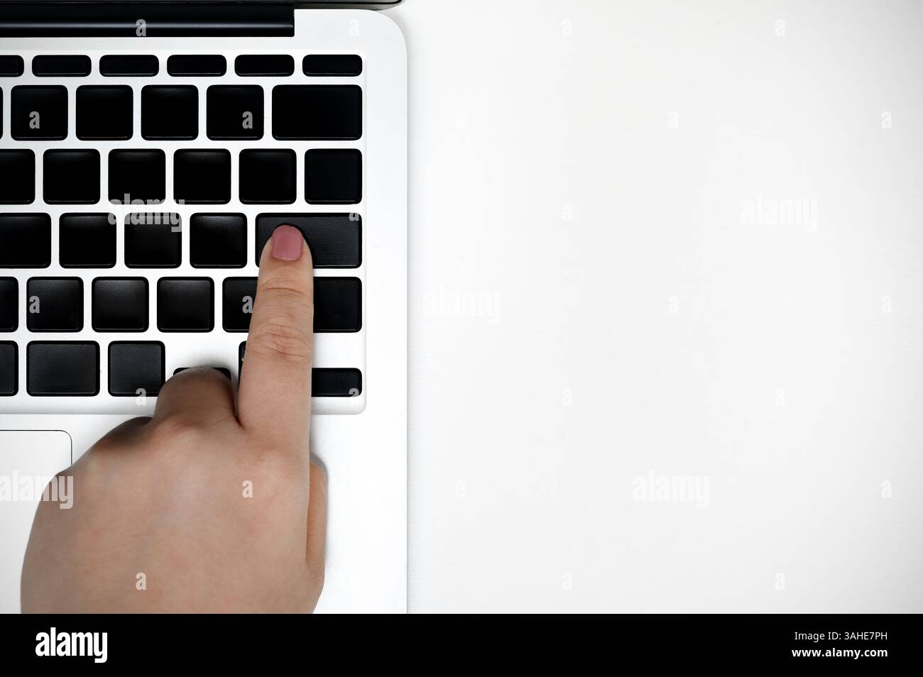 a hand with Index finger touch on computer keyboard's blank black color ...