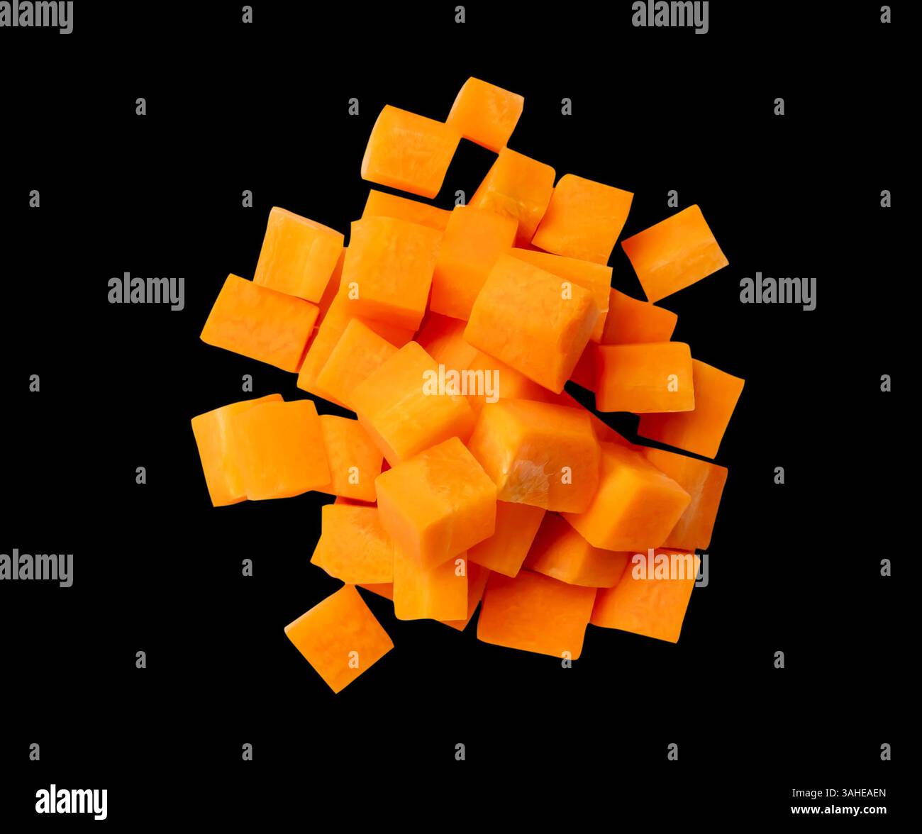 Top view of orange carrot slices in cube shape in stack is isolated on ...