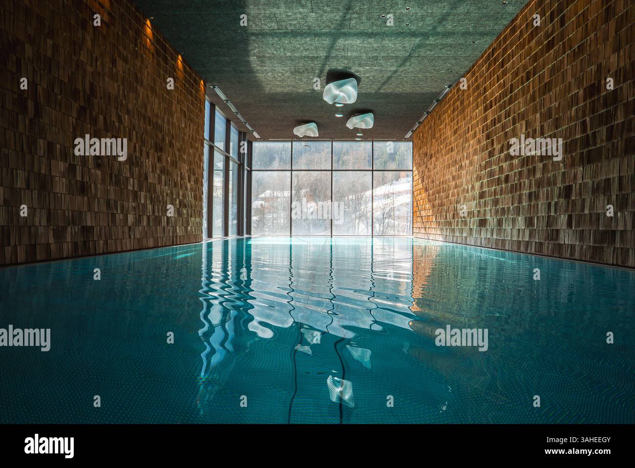 Indoor Pool with Alpine Views and Wooden Accents in Italian Alps Stock ...