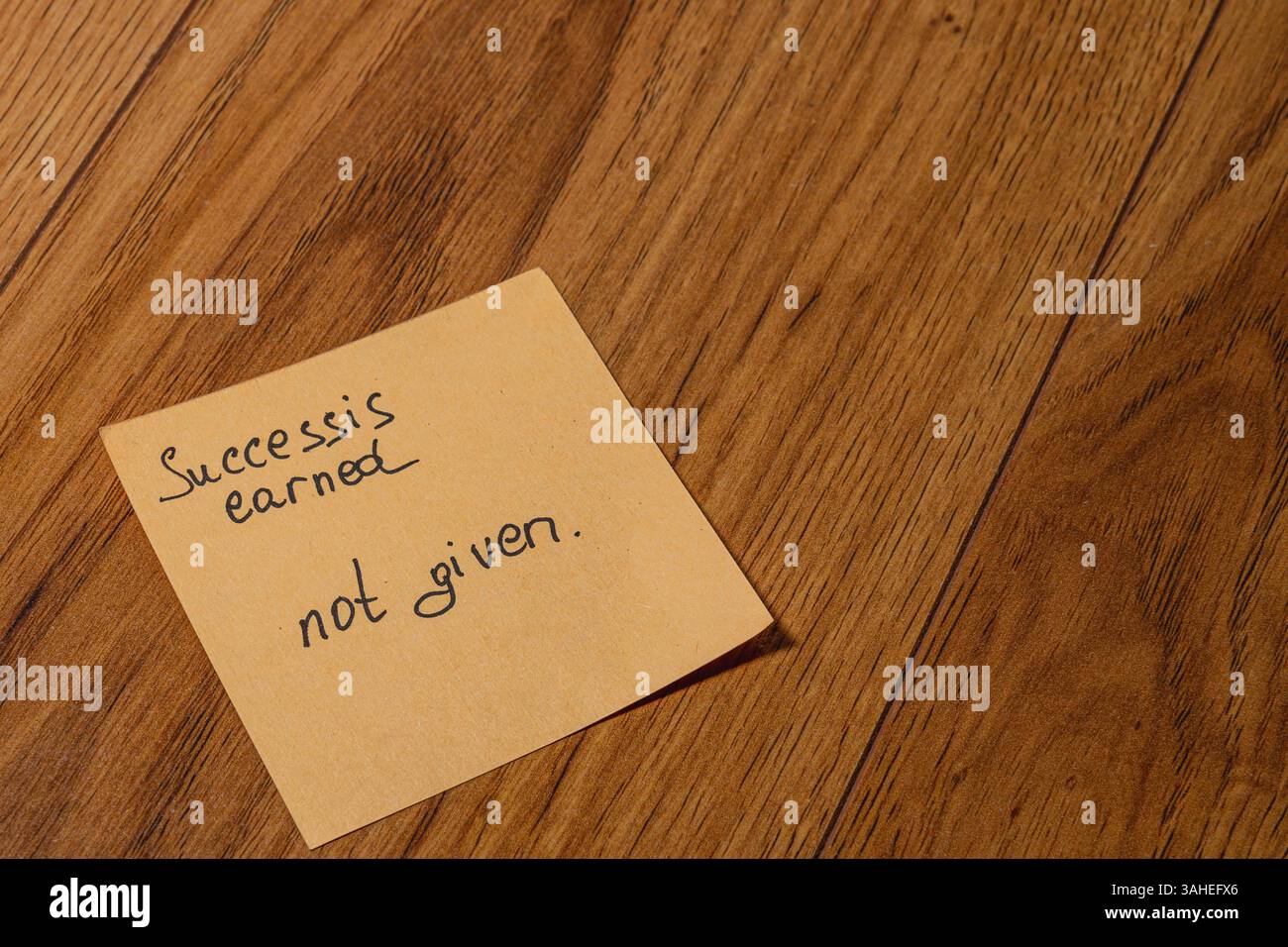 A handwritten note rests on a wooden floor, conveying a powerful ...