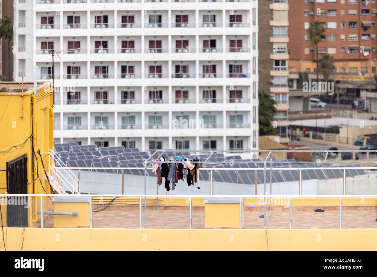 Photo of clean clothes drying and pegged on a washing line on top of a ...