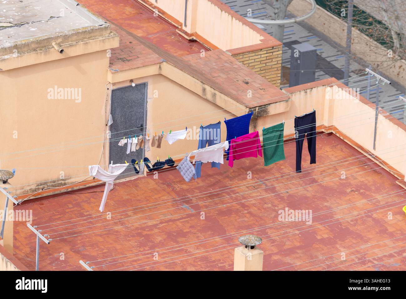 Photo of clean clothes drying and pegged on a washing line on top of a ...