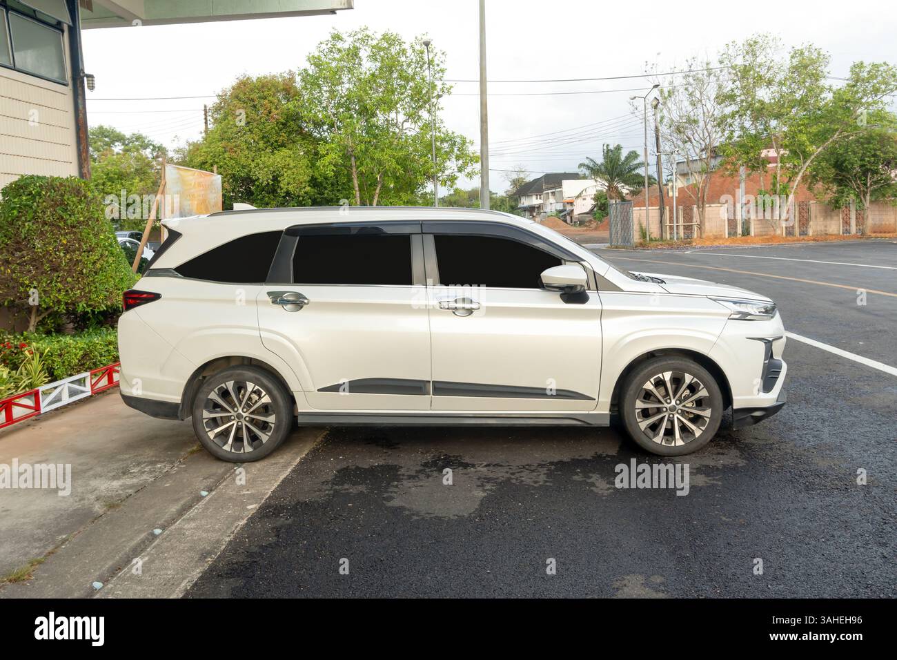 White sport SUV car with right side view is parking in open area in ...