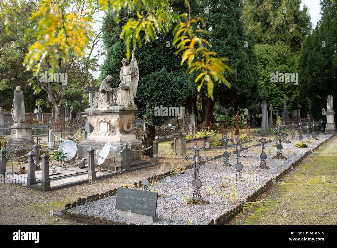 View at the cemetery of Roermond with graves of nuns at the right and a ...