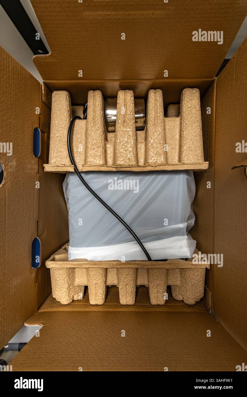 Taking a new coffee machine out of the cardboard box, unpacking a new ...