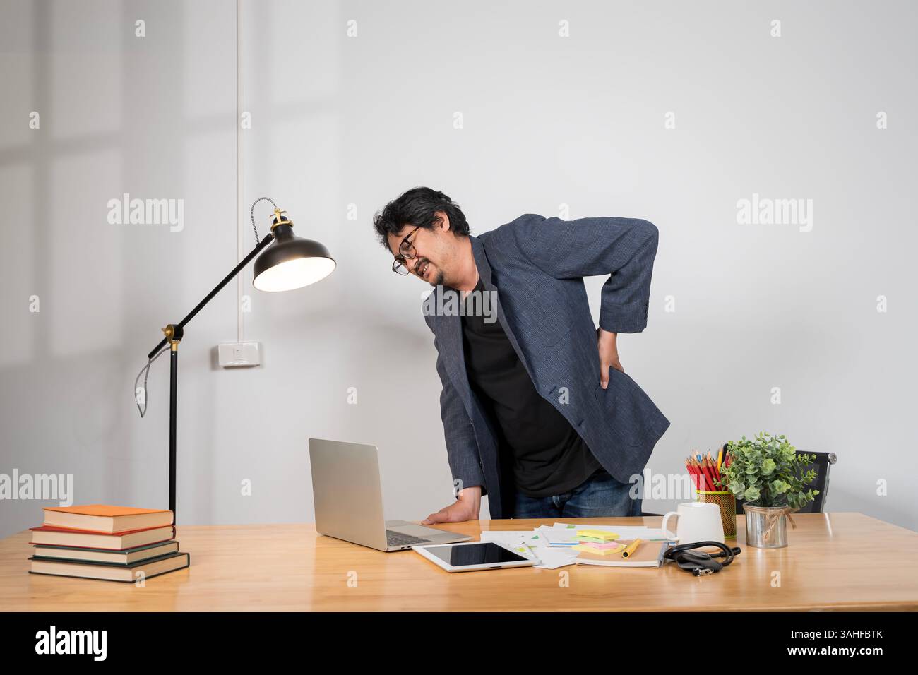 Stressed young businessman having back hi-res stock photography and ...