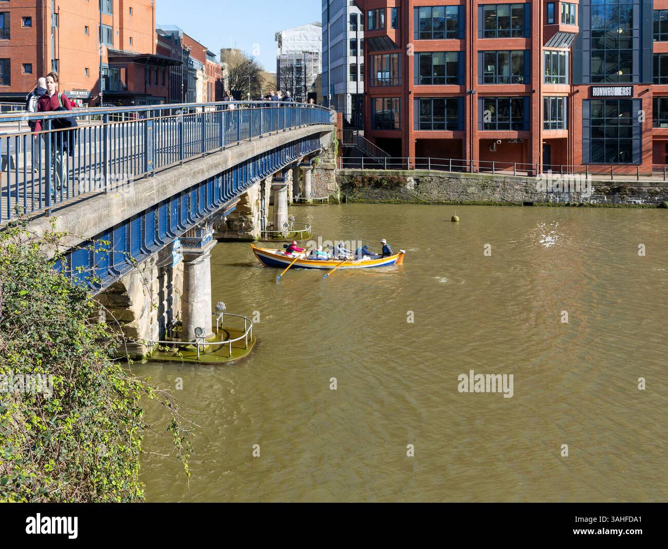 Rowing boat on River Avon Floating Harbour approaching, Bristol Bridge ...