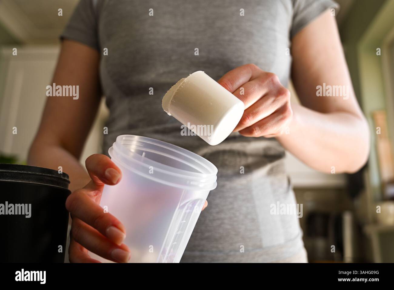 Protein powder. Female hand pouring protein powder in a shaker, food ...