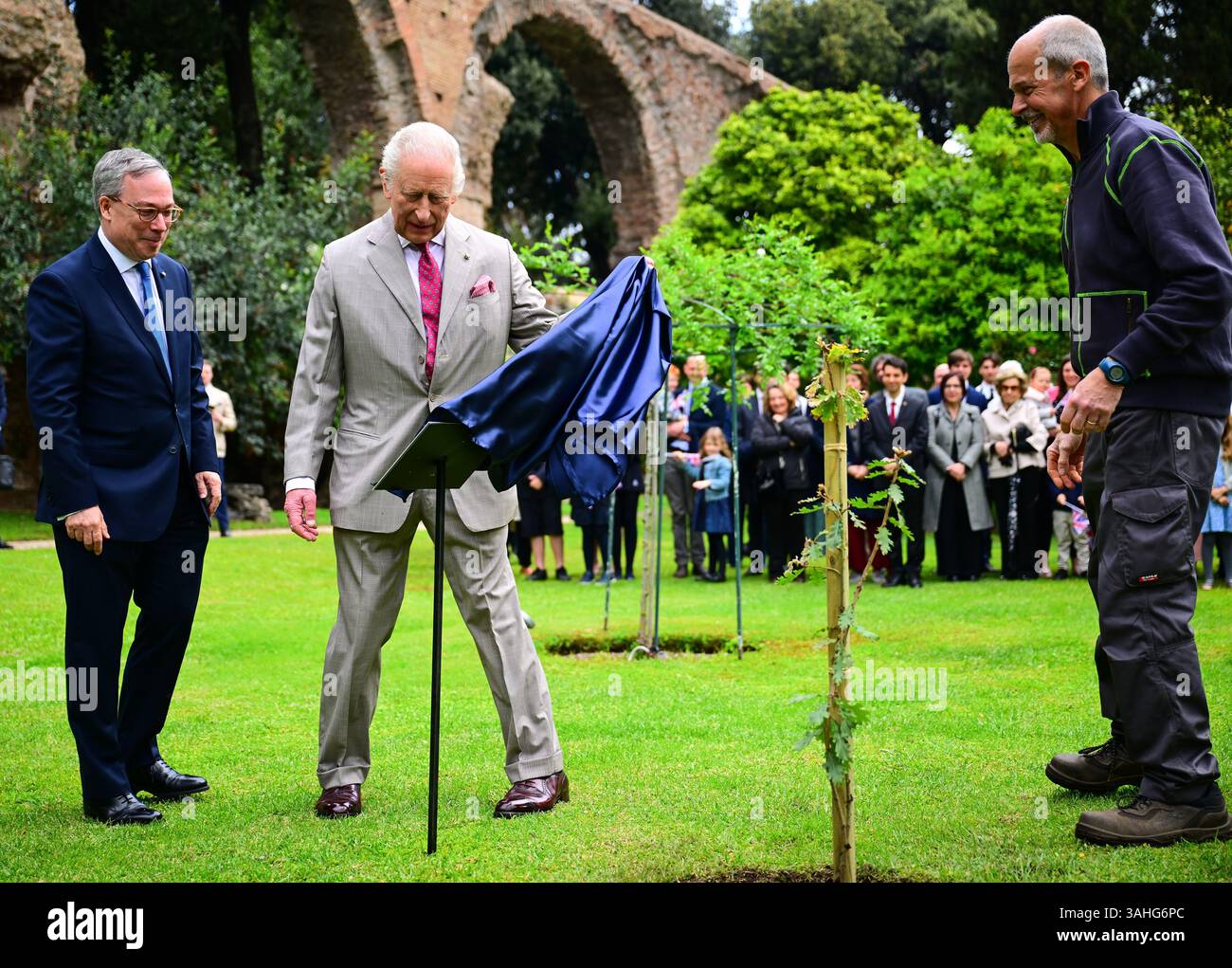King Charles III unveils a plaque after planting a tree donated by ...