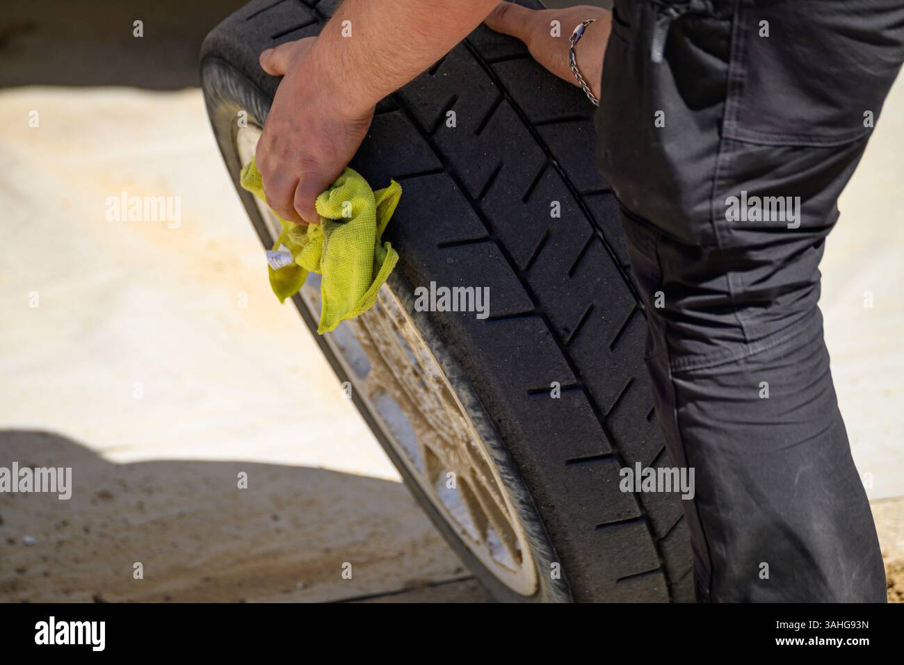 race tire closeup maintenance detail mechanic work on race car in pit ...