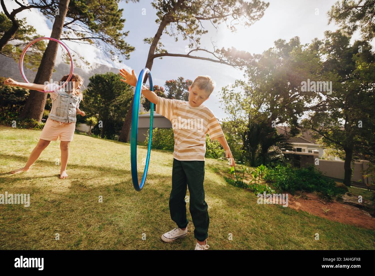 Children outdoors enjoying playtime with colorful hula hoops on a ...