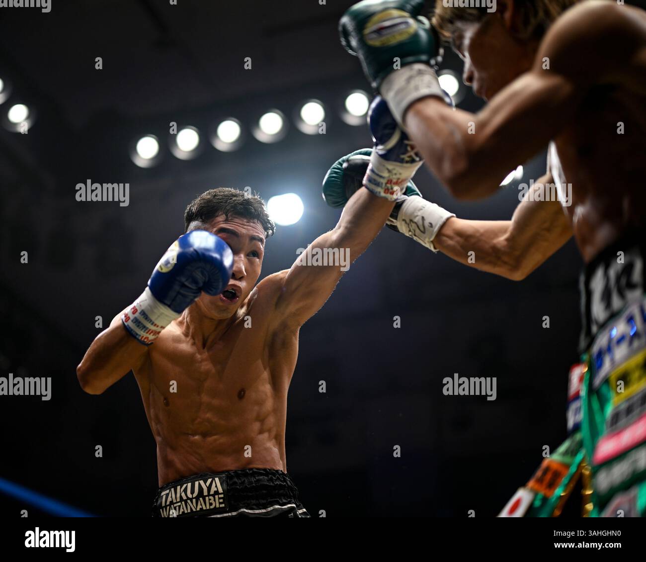 Tokyo, Japan. 5th Apr, 2025. Challenger Takuya Watanabe (blue gloves) throws a left at champion ...