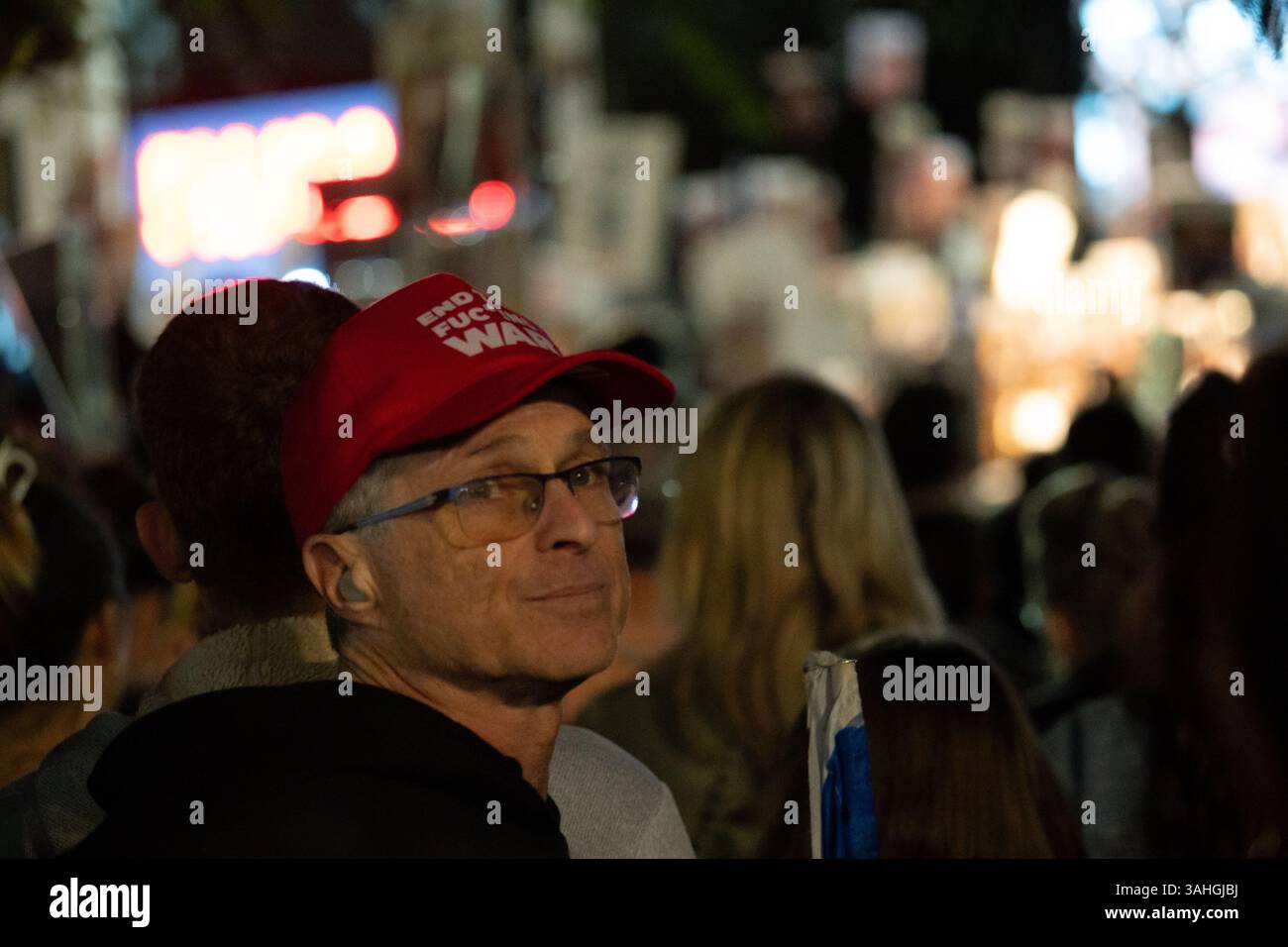A protester wears a red anti-war hat during a rally at Hostage Square ...