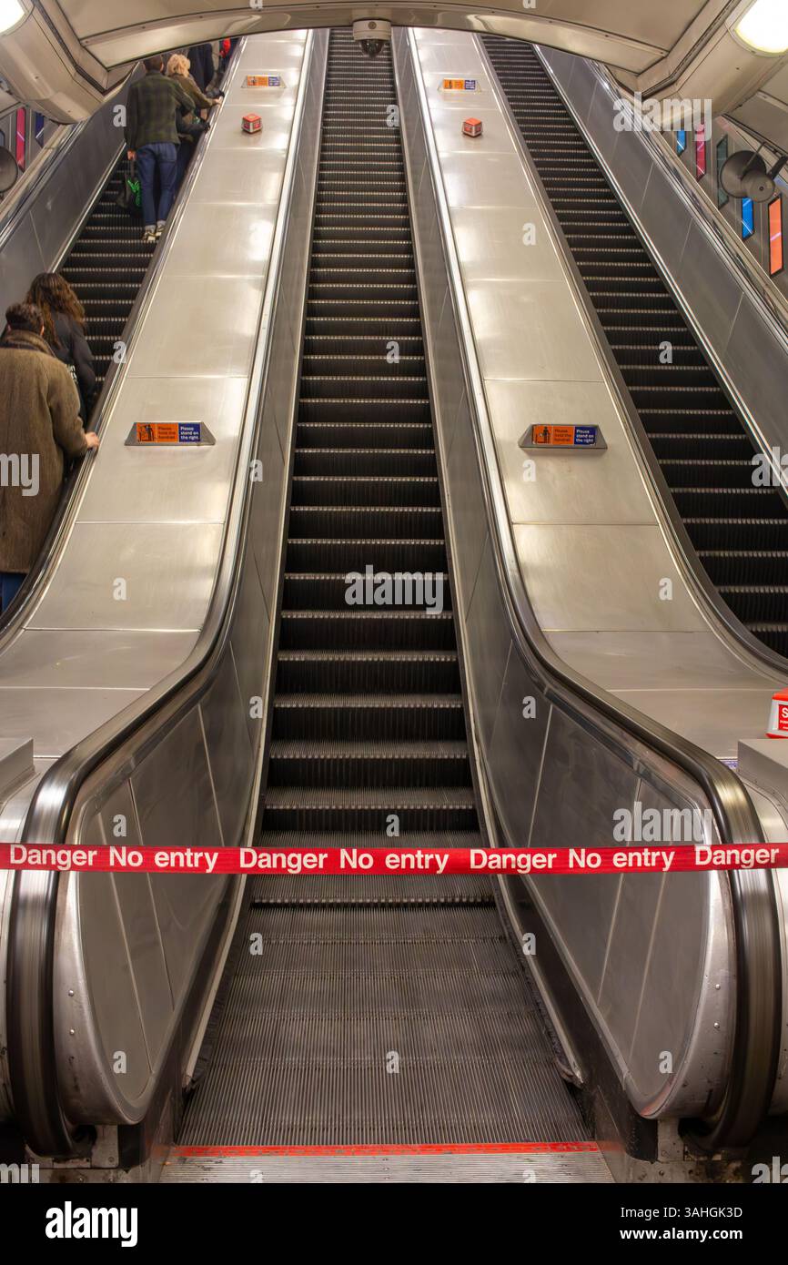 A closed escalator in a Tube station on the London Underground with a ...
