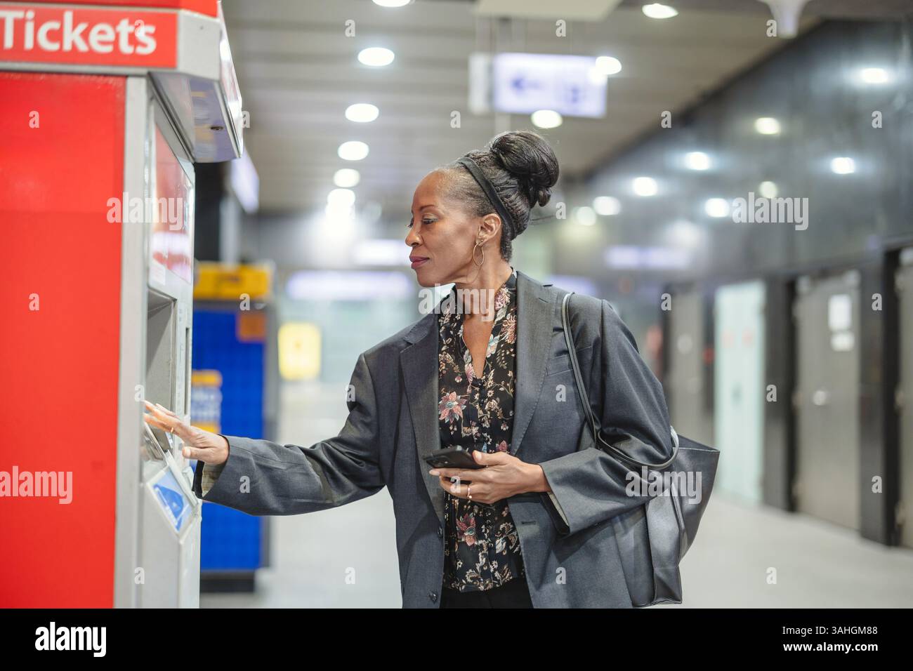 Woman buying a public transport ticket from a machine Stock Photo - Alamy