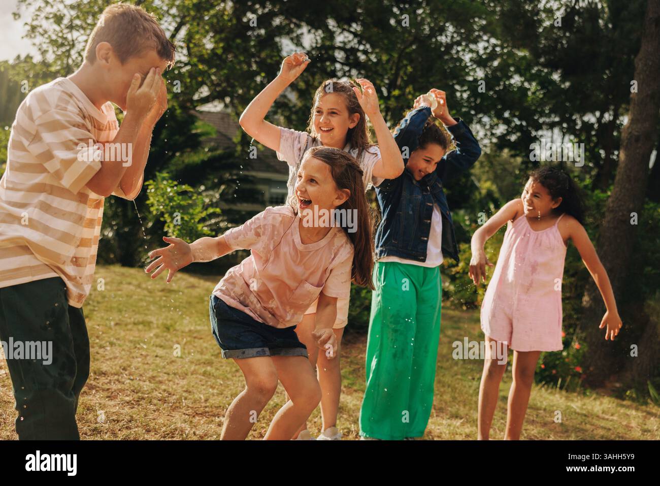 A group of children enjoy a fun outdoor activity, expressing happiness ...