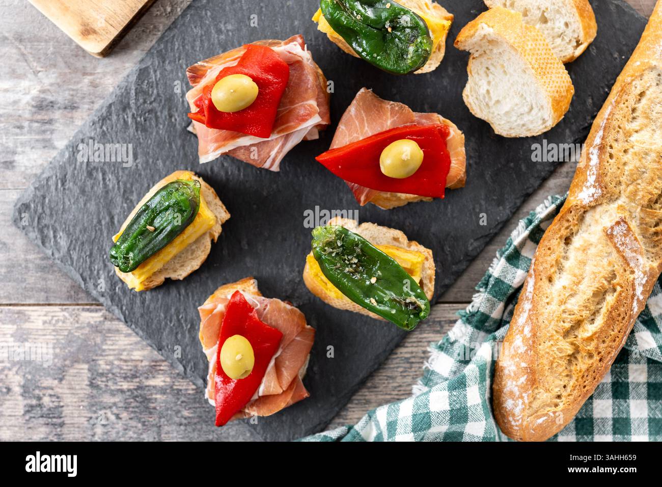 Traditional Spanish pintxos on wooden table Stock Photo - Alamy