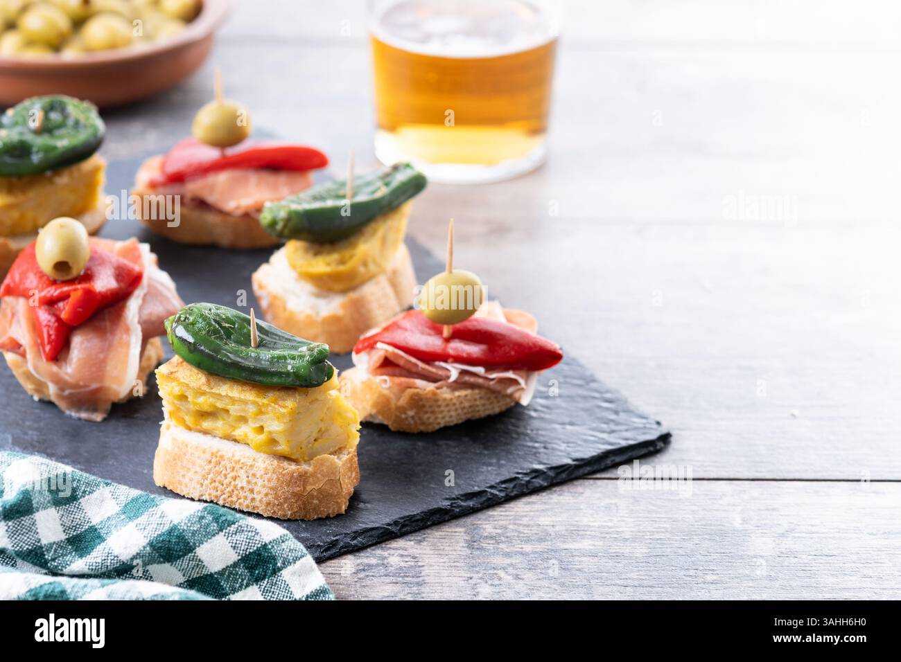 Traditional Spanish pintxos on wooden table Stock Photo - Alamy