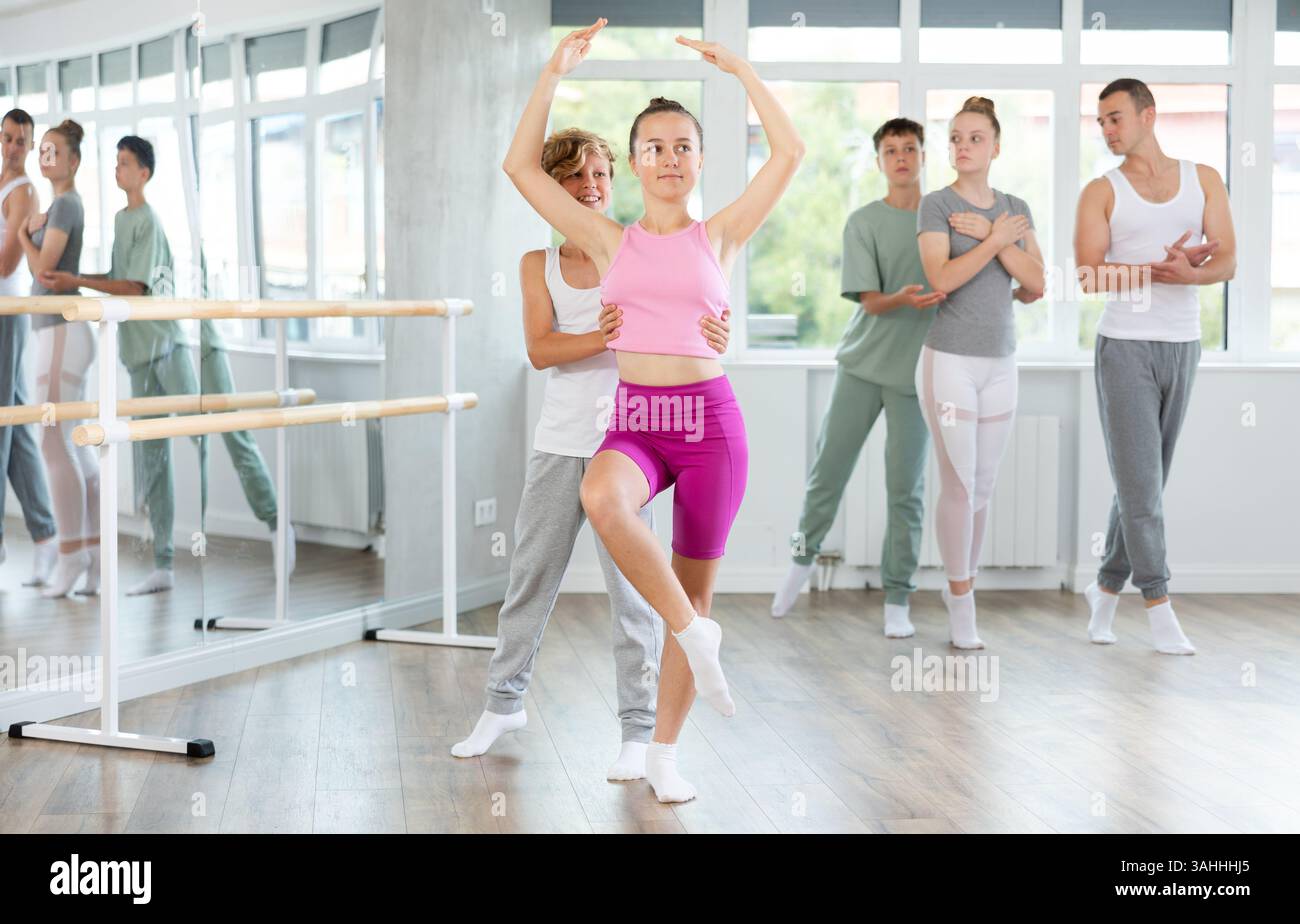 Ballet studio - teenagers girls and boys learn ballet movements in ...