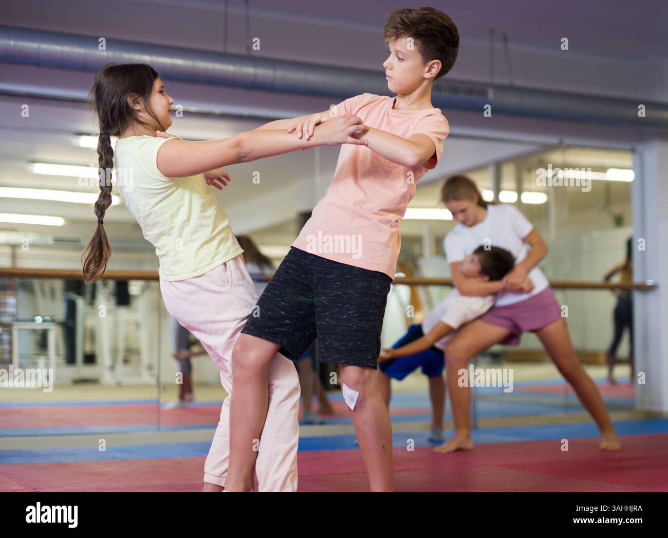 Kids learning self-defence moves in gym Stock Photo - Alamy