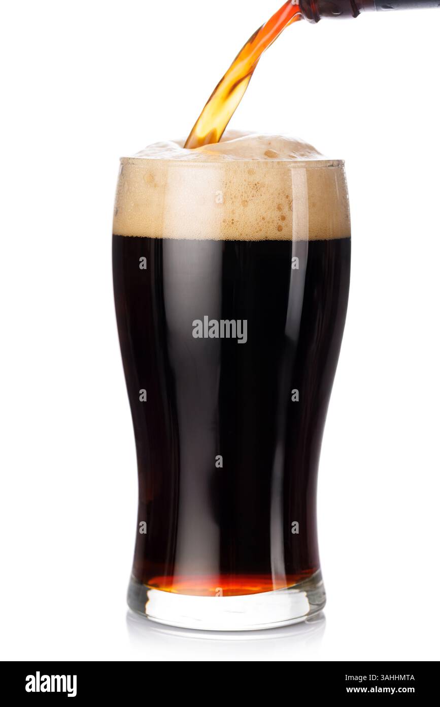 A tall glass of dark stout beer with frothy head, isolated on a clean ...