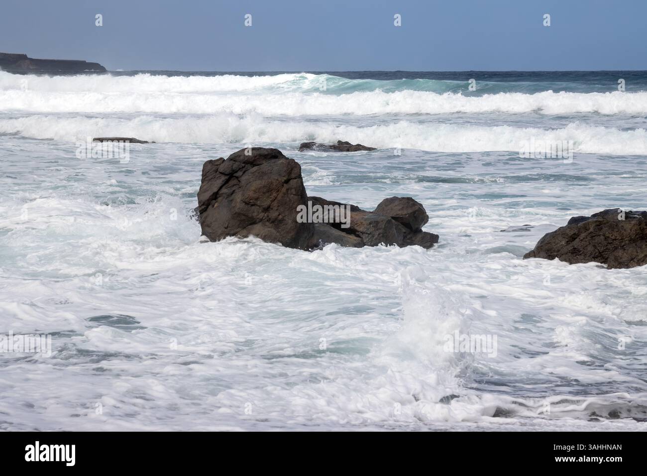 Big volcanic black rocks on the coast of Atlantic ocean with intense ...