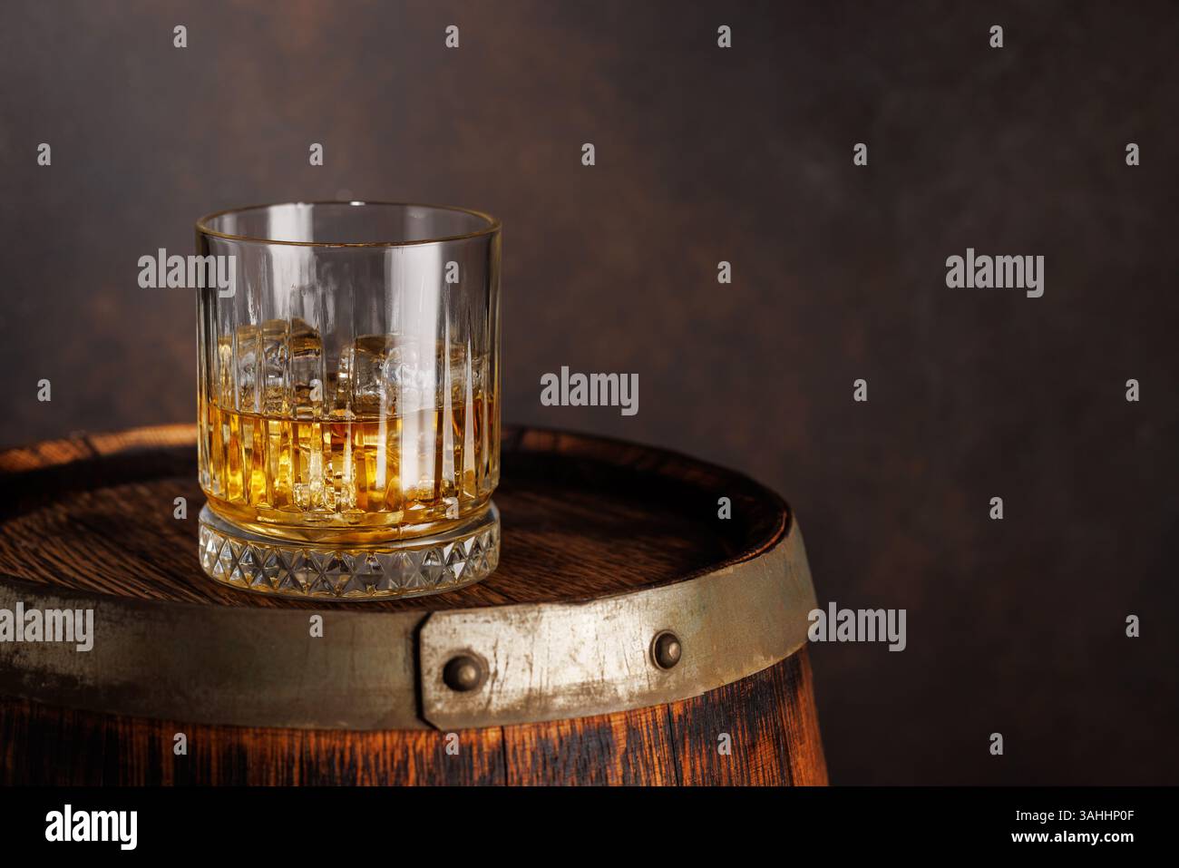A classic whiskey glass filled with golden amber whiskey, placed on a ...